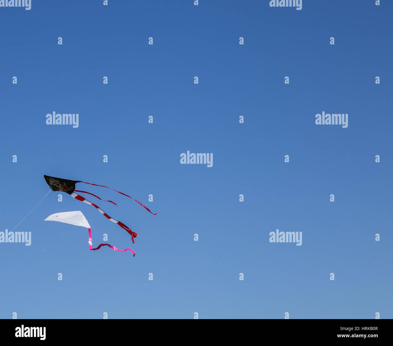 Kite hit from the Sun on a background of blue sky Stock Photo - Alamy