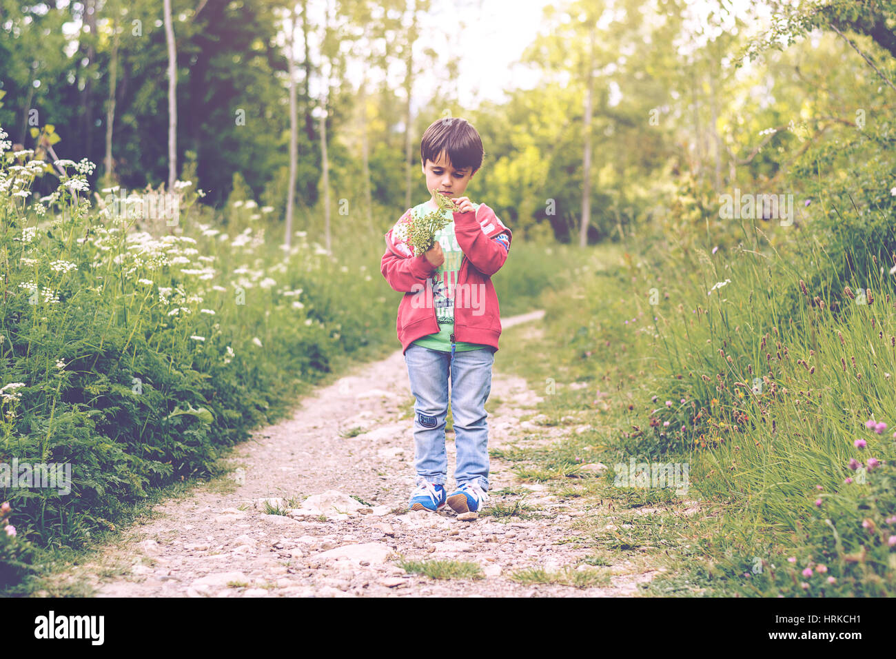 child with spring flowers. Child outdoor portrait Stock Photo - Alamy
