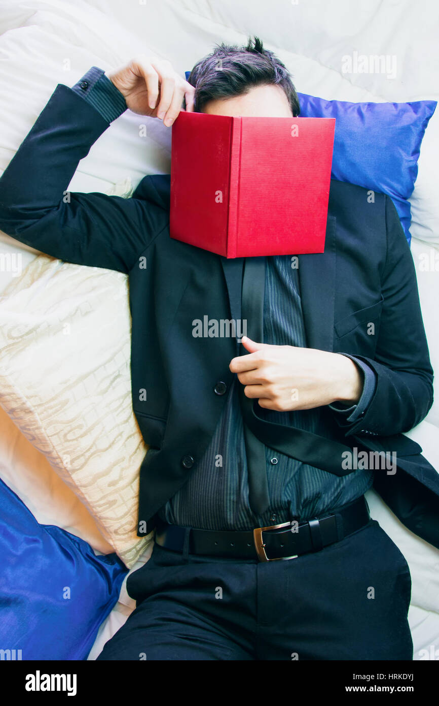 Young man sleeping with a book over him Stock Photo - Alamy
