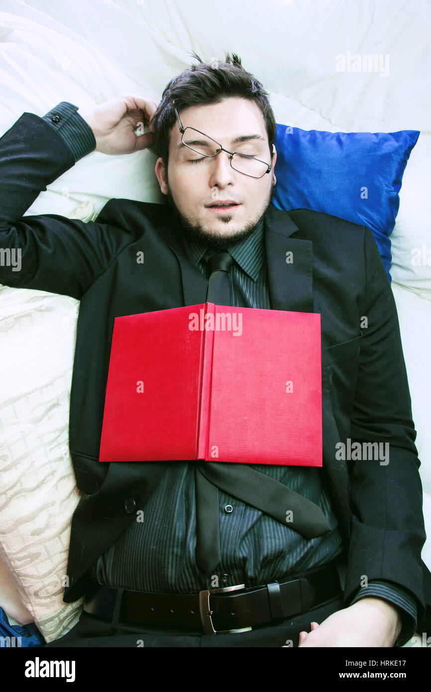 Young man sleeping with a book over him Stock Photo - Alamy
