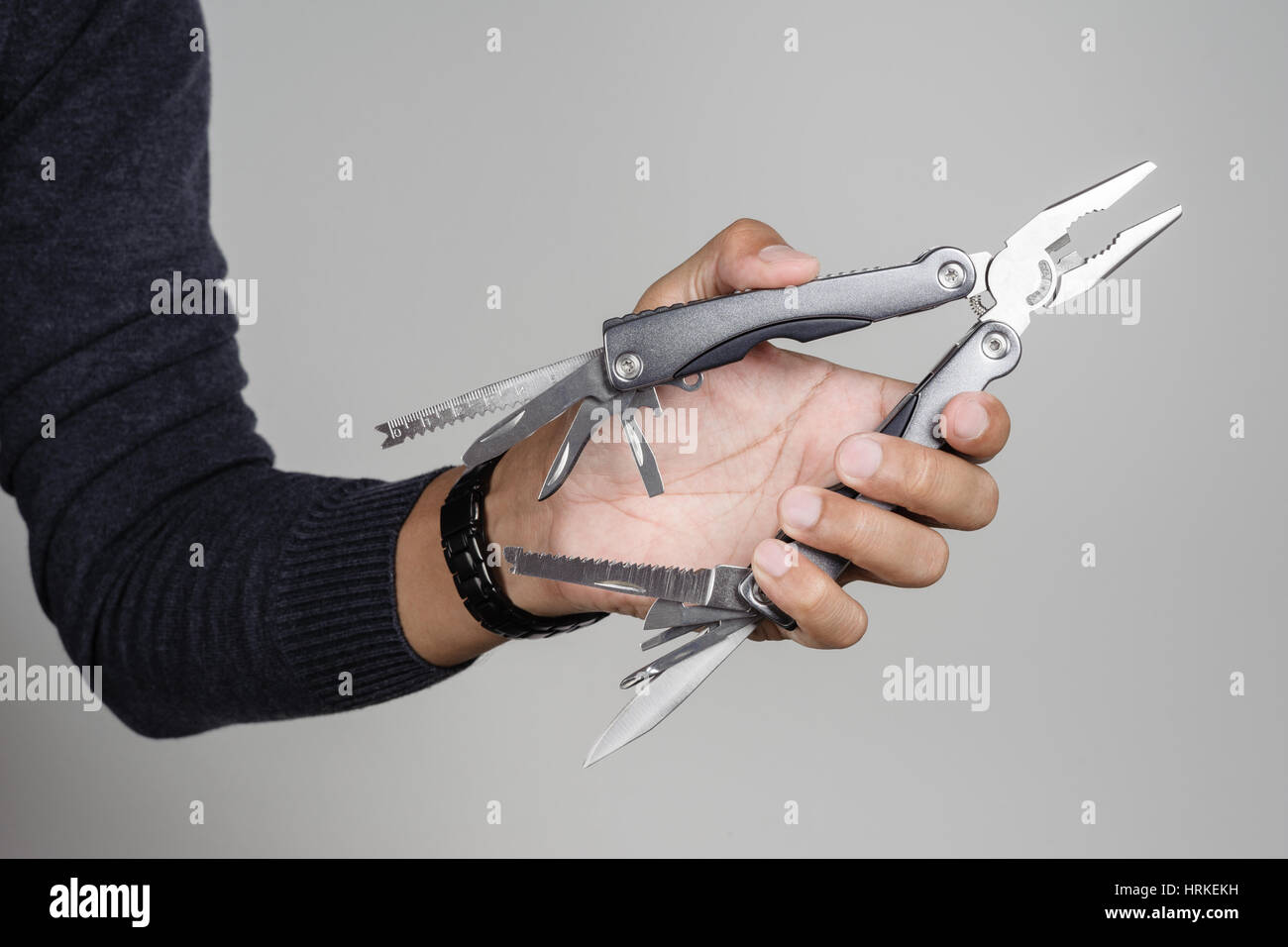 closeup multifunction stainless steel knife in hand Stock Photo - Alamy