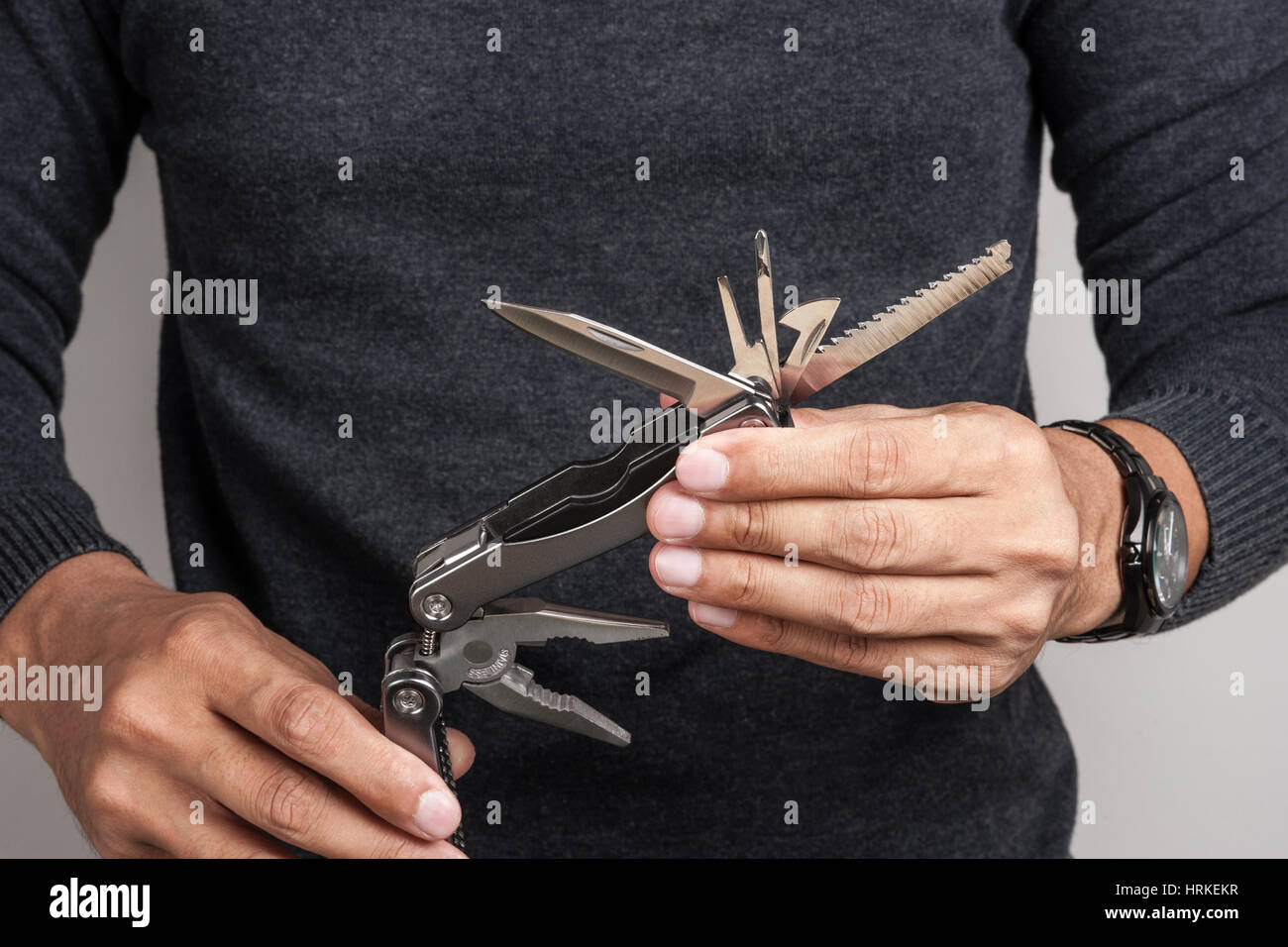 closeup multifunction stainless steel knife in hand Stock Photo - Alamy