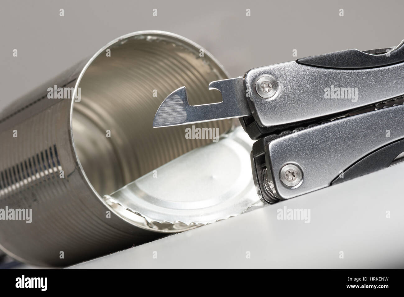 opening the tin with tin opener (can opener Stock Photo - Alamy