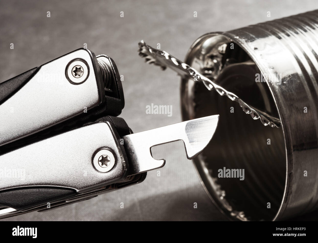 opening the tin with tin opener (can opener Stock Photo - Alamy