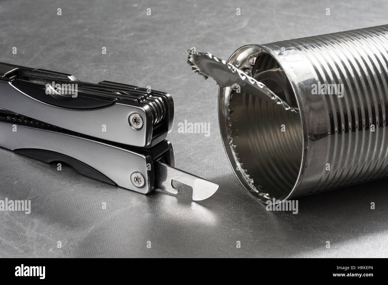 opening the tin with tin opener (can opener Stock Photo - Alamy