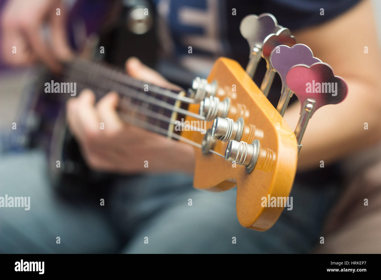 young man plays bass guitar Stock Photo - Alamy