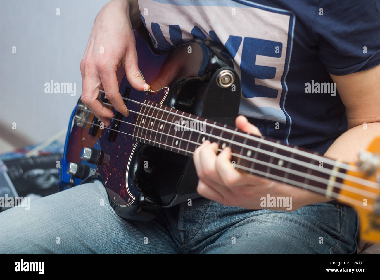 young man plays bass guitar Stock Photo - Alamy