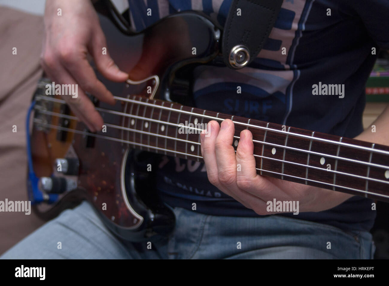 young man plays bass guitar Stock Photo - Alamy