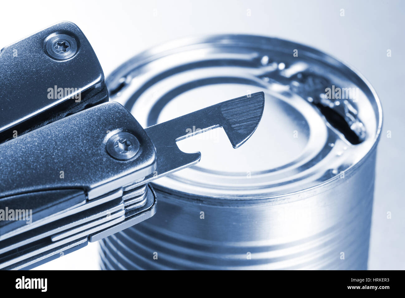 opening the tin with tin opener (can opener Stock Photo - Alamy