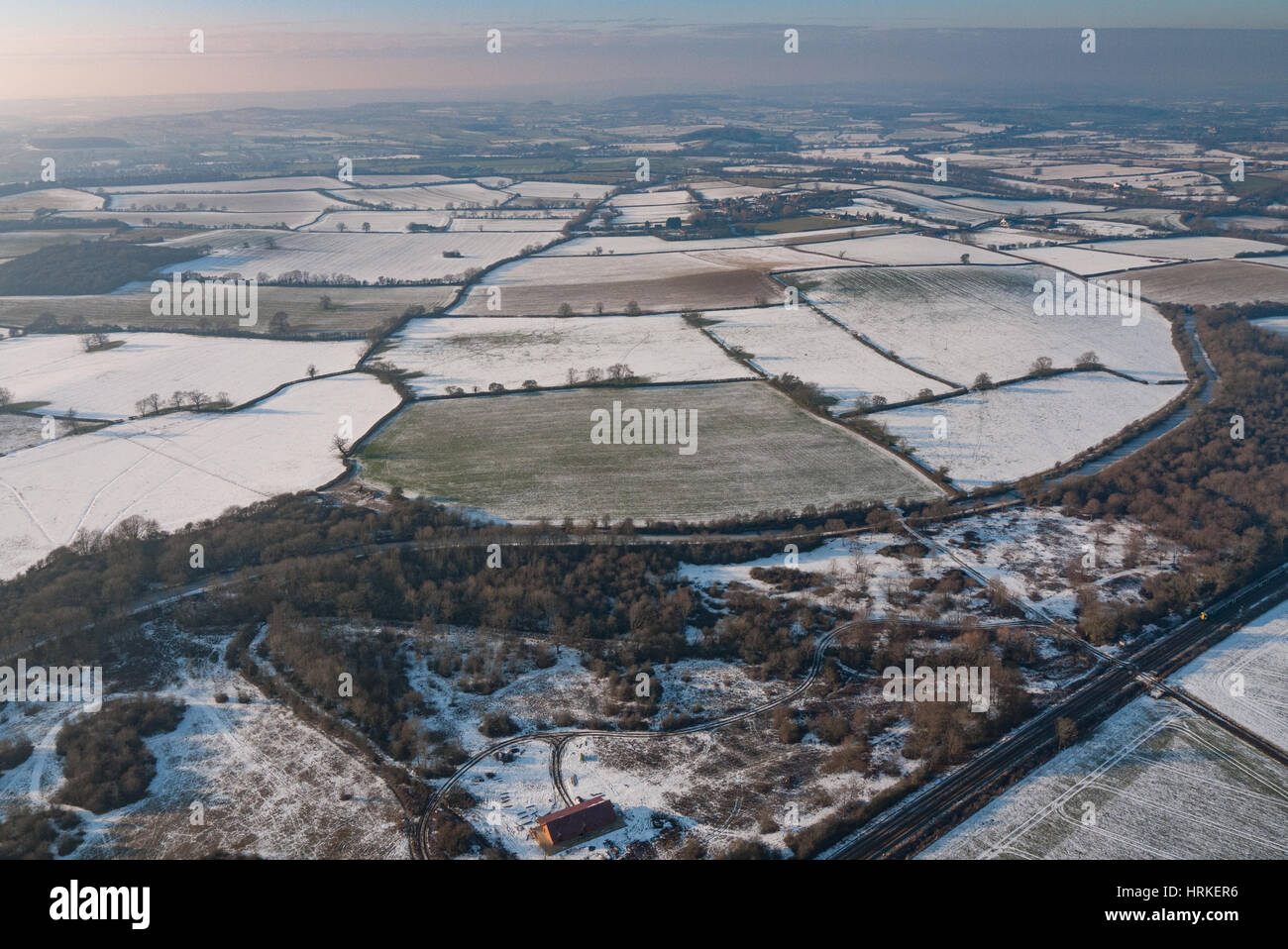 Aerial view of fields in winter with a light covering of snow ...