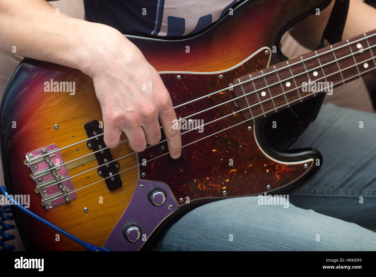 young man plays bass guitar Stock Photo - Alamy