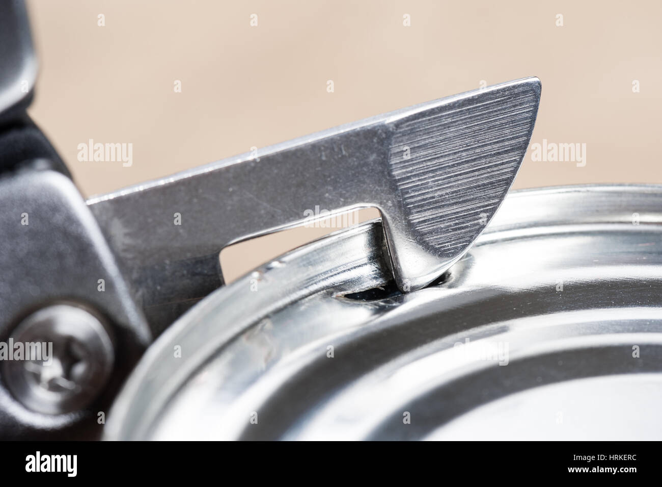 opening the tin with tin opener (can opener Stock Photo - Alamy