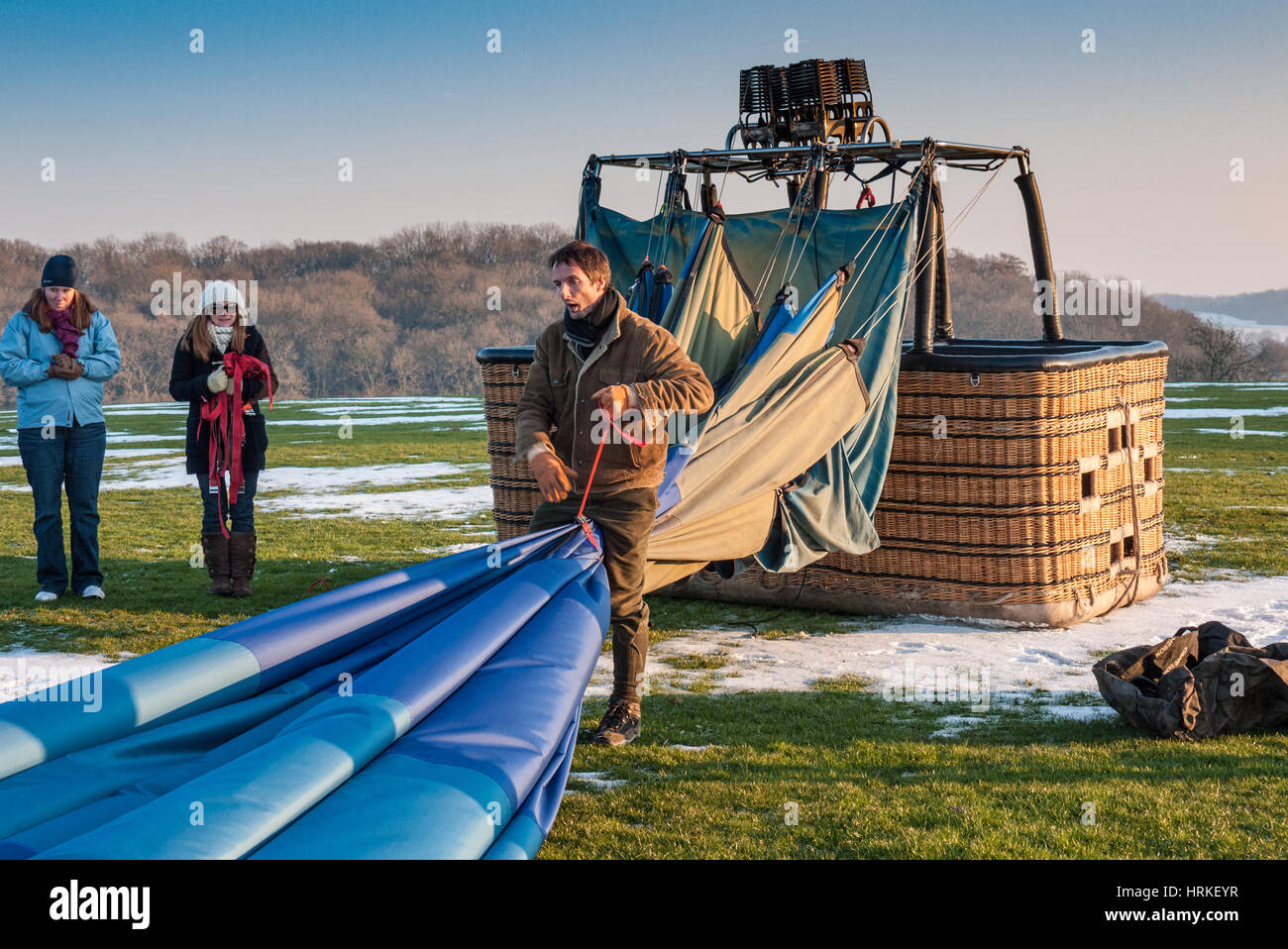 Packing up the envelope of a hot air balloon having landed after a ...