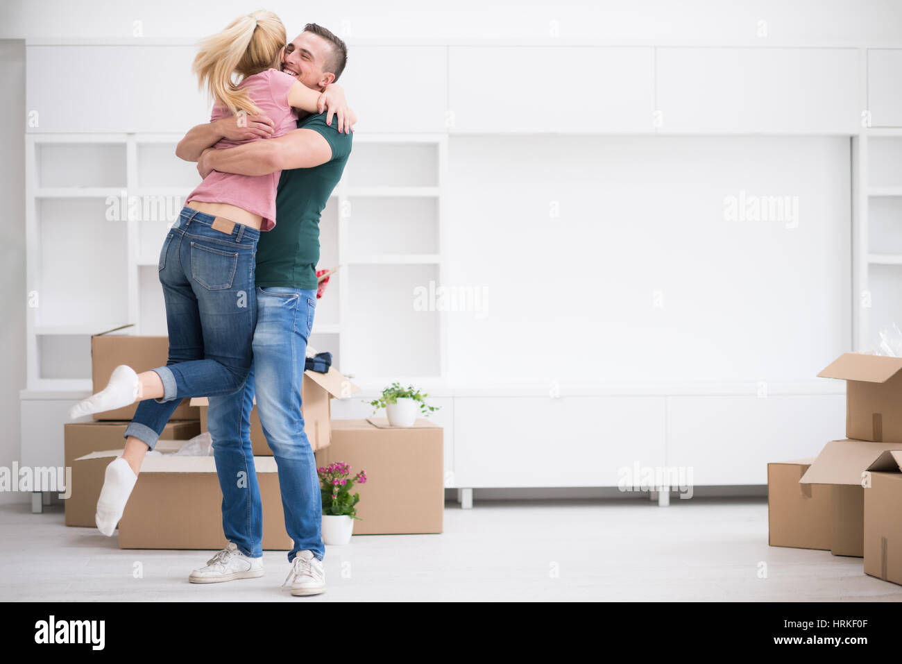 excited happy young couple looking forward to moving into a new home ...