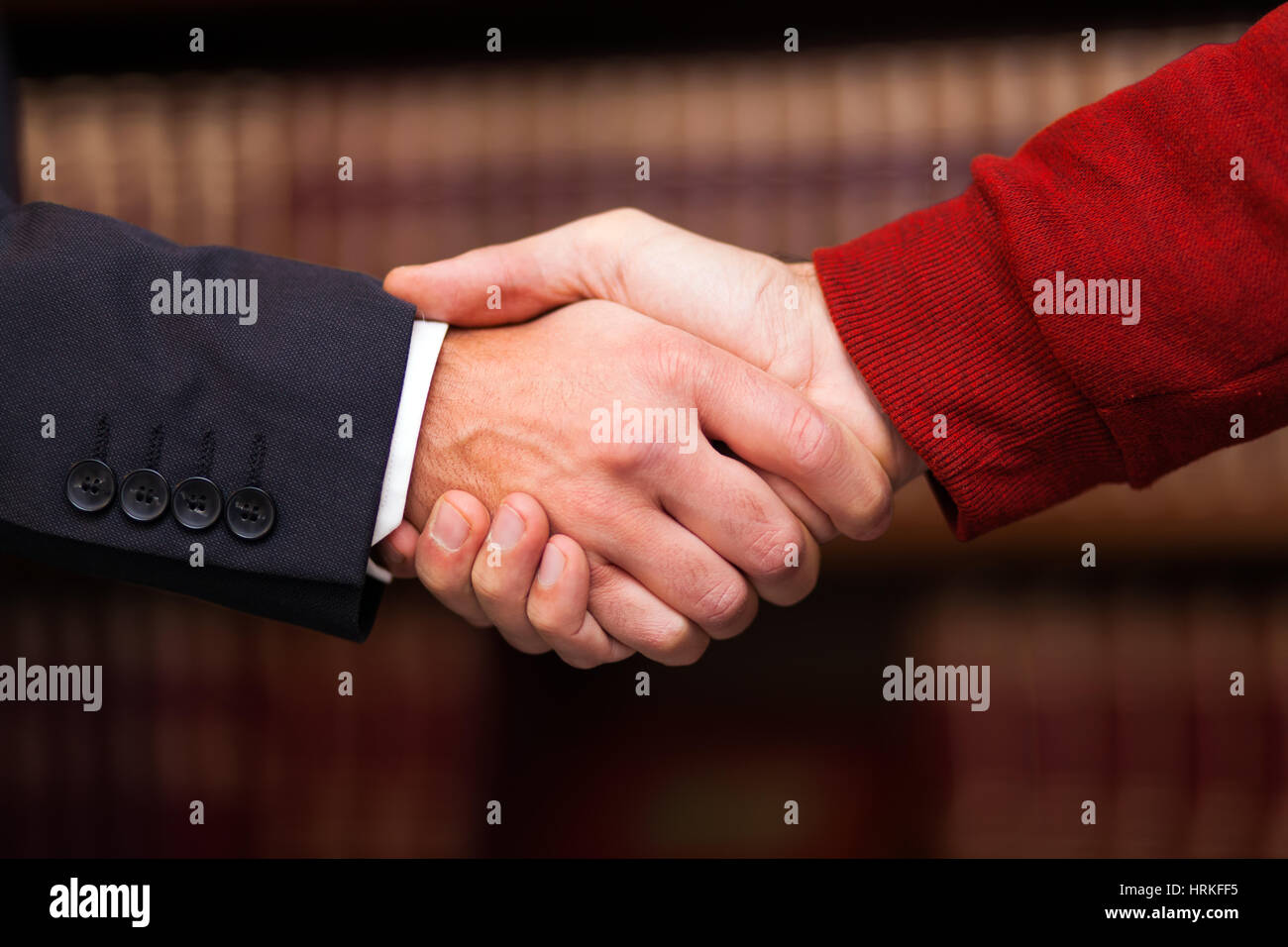 Businessman giving an handshake to a customer Stock Photo - Alamy