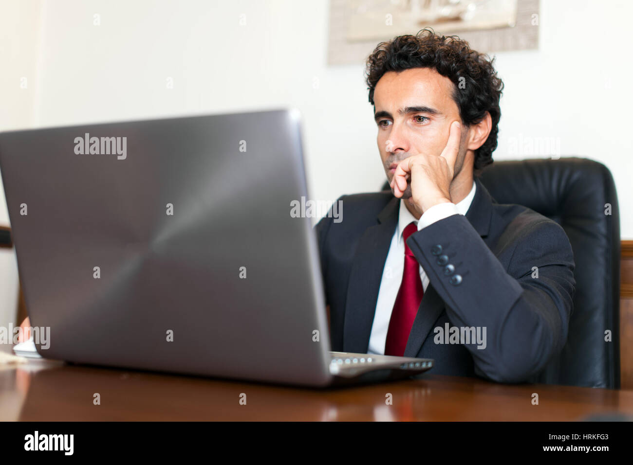 Businessman using a computer in his office Stock Photo - Alamy