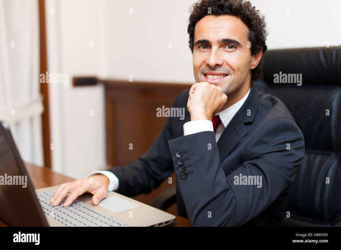 Businessman using a computer in his office Stock Photo - Alamy