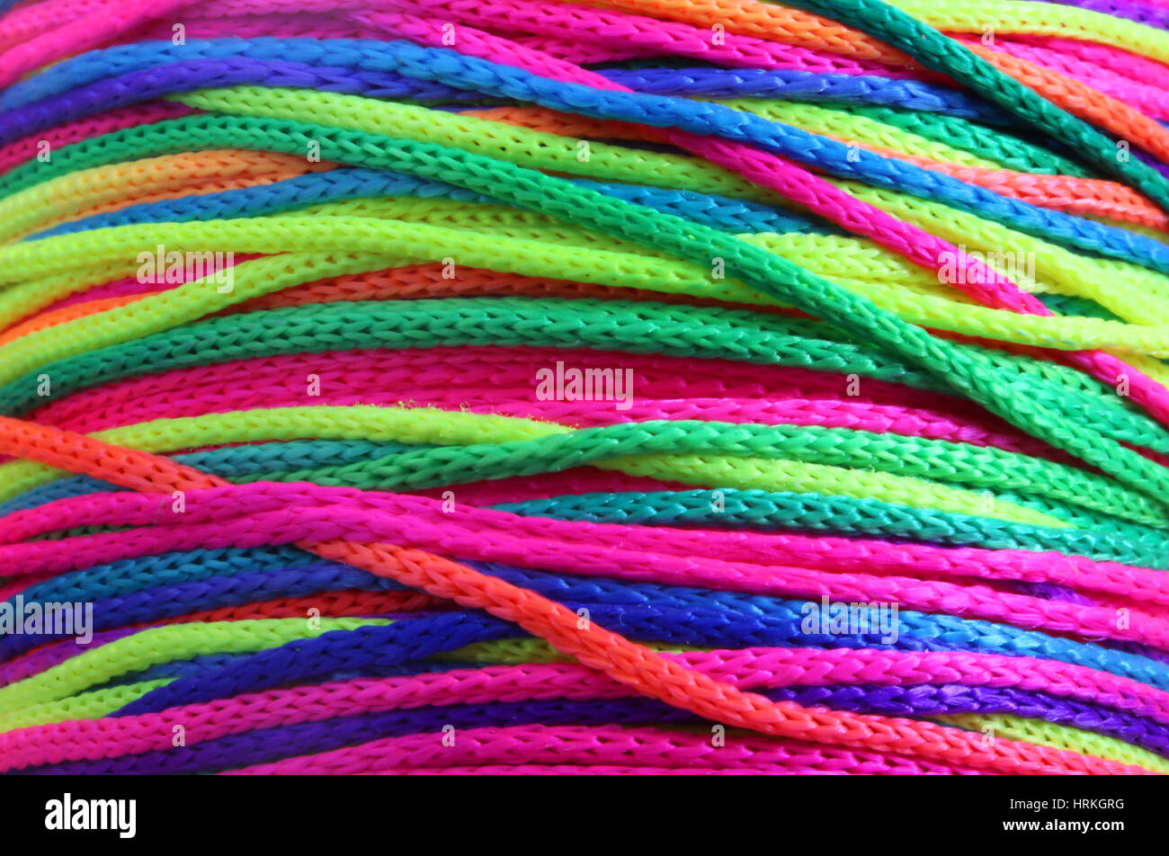 rainbow closeup background with string band green red phosphorescent ...