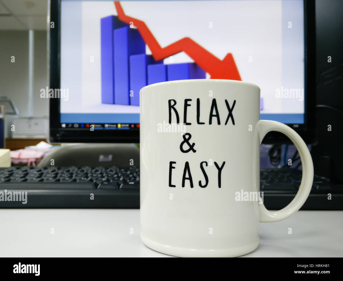 Front view of the personal computer and a cup is on the work table ...