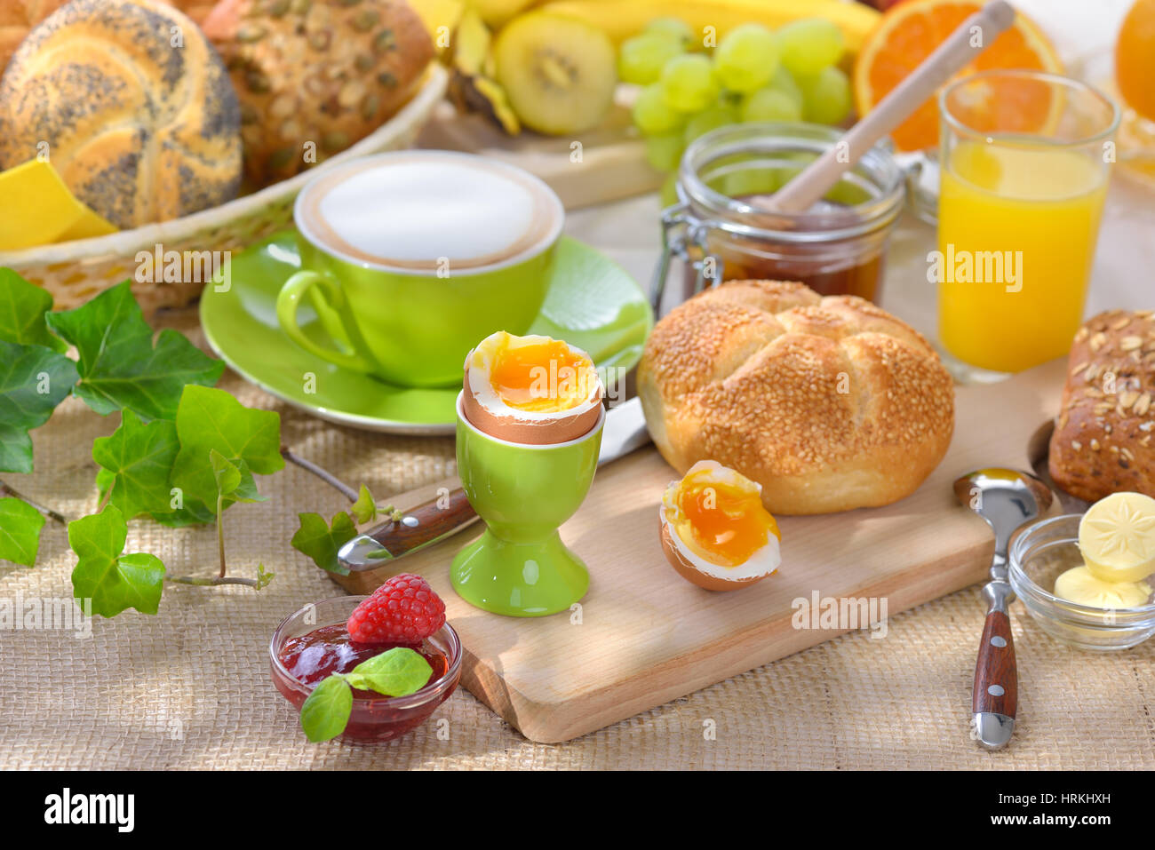 Outside served breakfast with a soft boiled egg and fresh rolls Stock ...