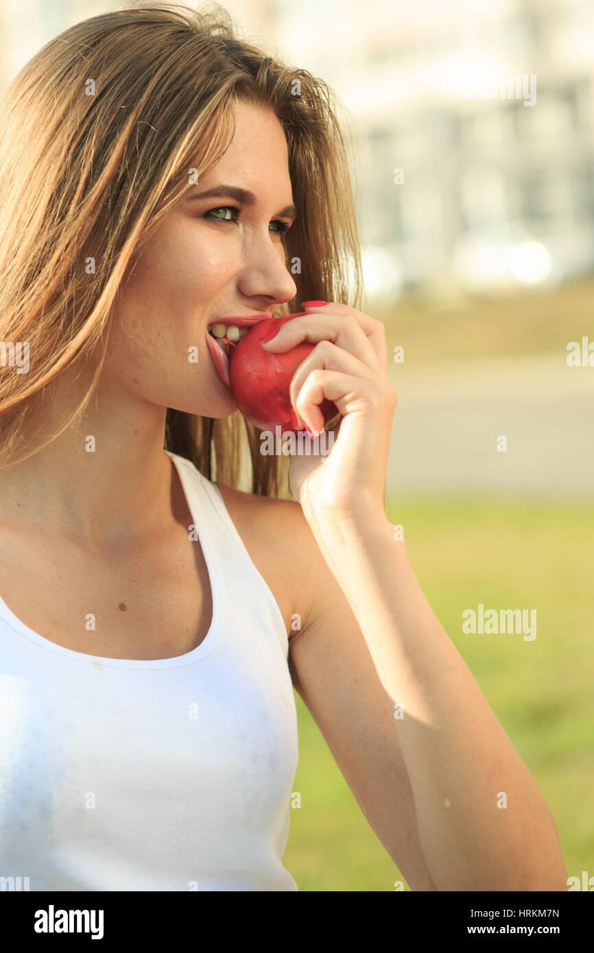 closeup beautiful girl portrait holding apple. eating fruit Stock Photo ...