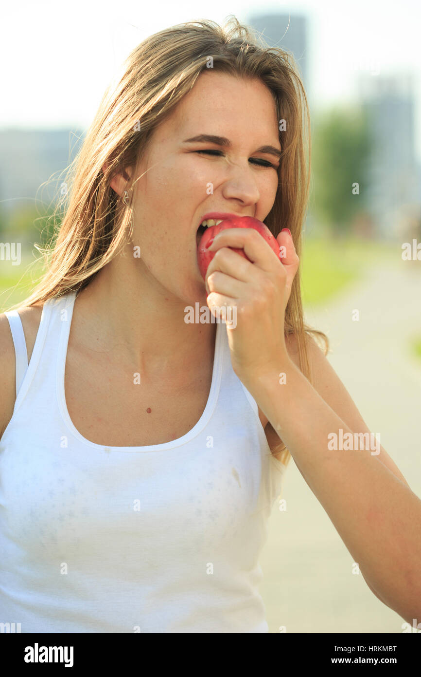 closeup beautiful girl portrait holding apple. eating fruit Stock Photo ...