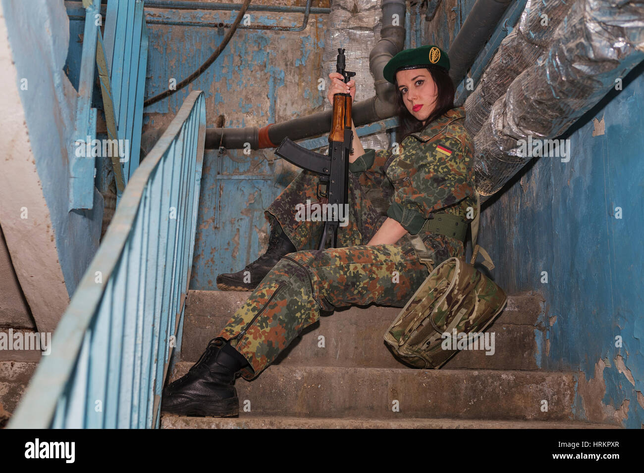 A girl with a firearm in her hands Stock Photo - Alamy