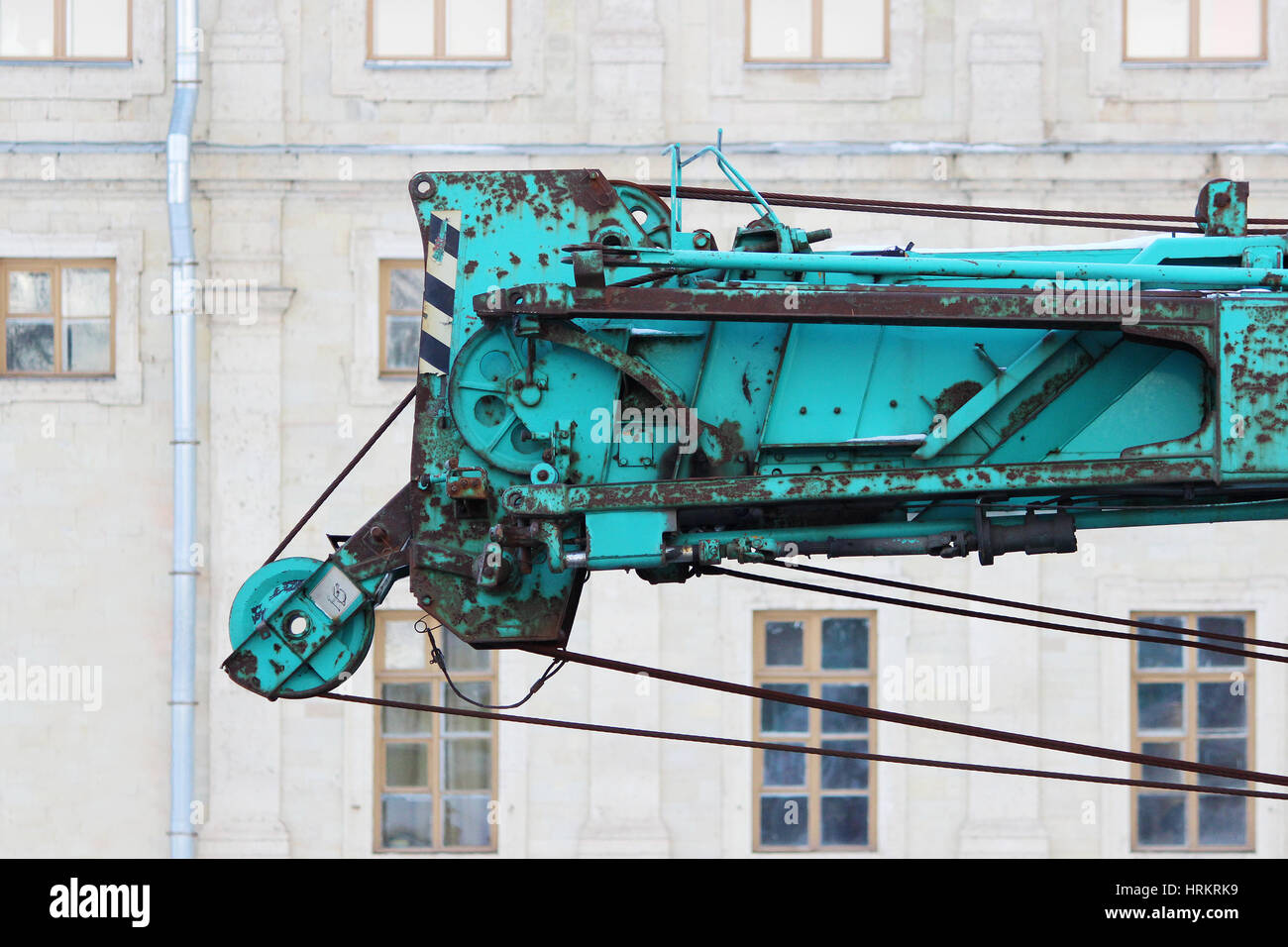 part of old working turquoise crane truck for construction on a ...