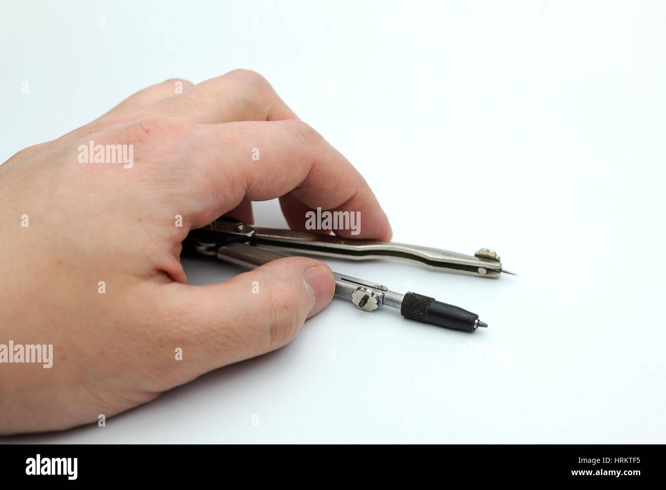Hand holding a compass on a white background Stock Photo - Alamy