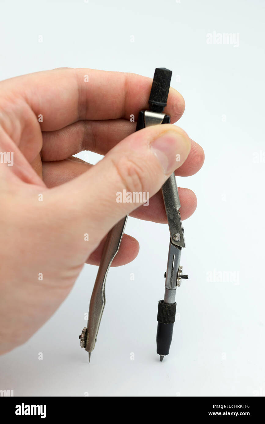 Hand holding a compass on a white background Stock Photo - Alamy