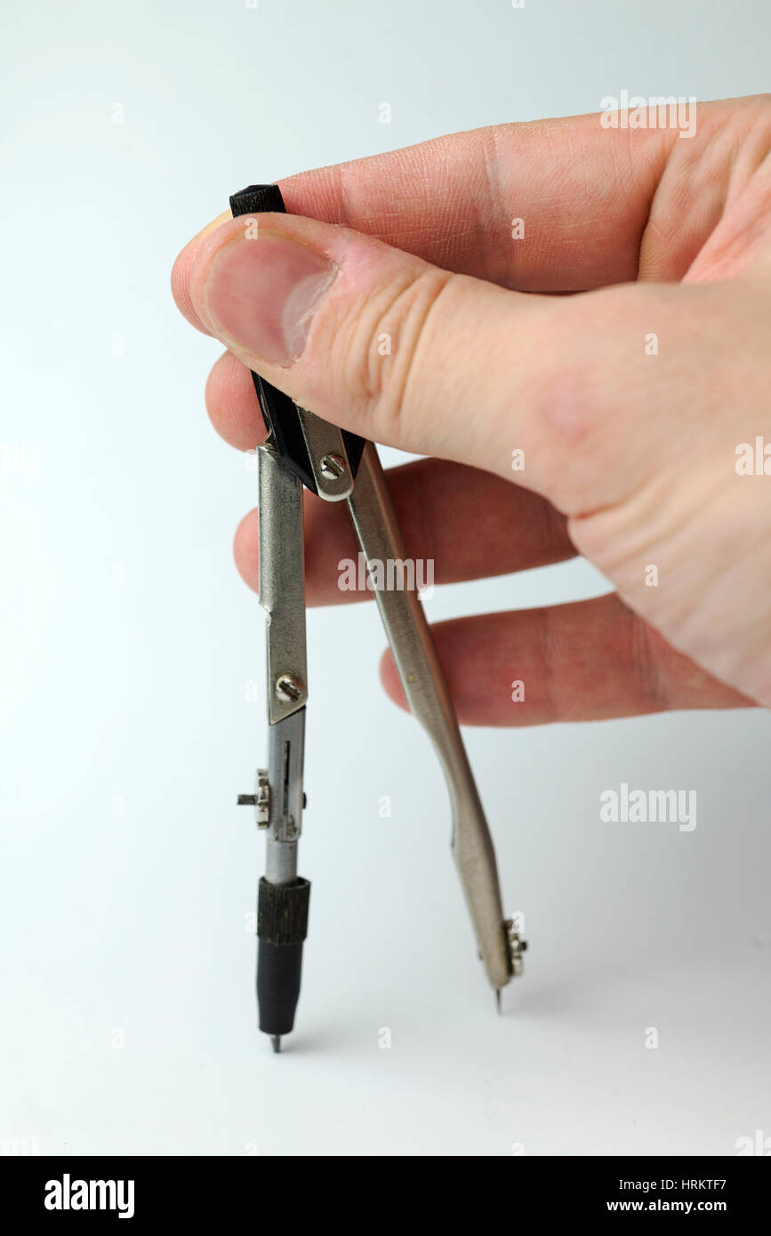 Hand holding a compass on a white background Stock Photo - Alamy