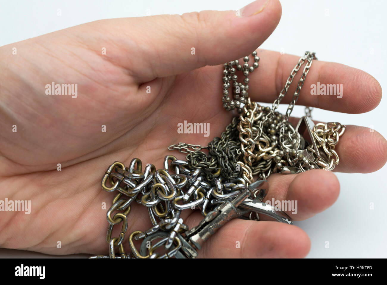 Hand holding a chain on a white background Stock Photo - Alamy