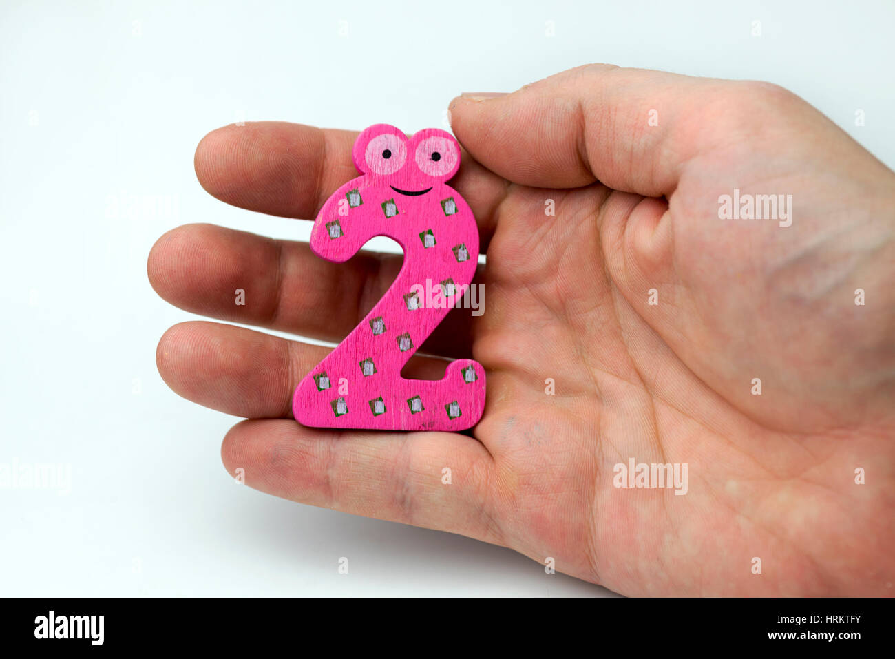 Hand holds the number two on white background Stock Photo - Alamy