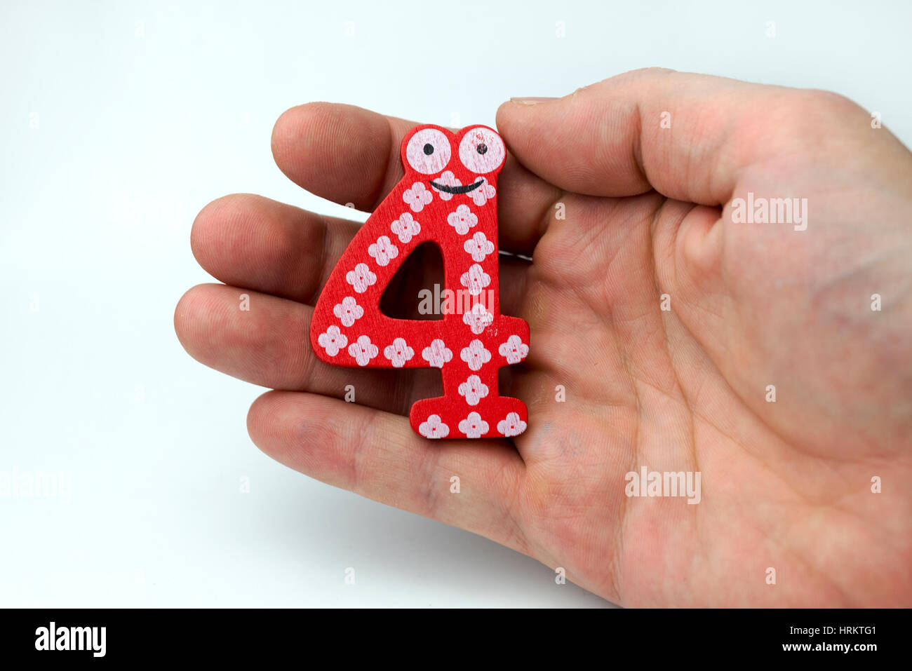 Hands holding a figure four on a white background Stock Photo - Alamy
