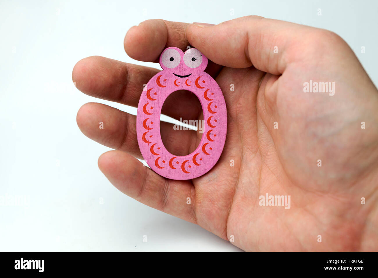 Hand holding number zero on white background Stock Photo - Alamy