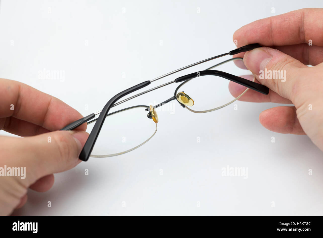 Hands holding glasses on white background Stock Photo - Alamy