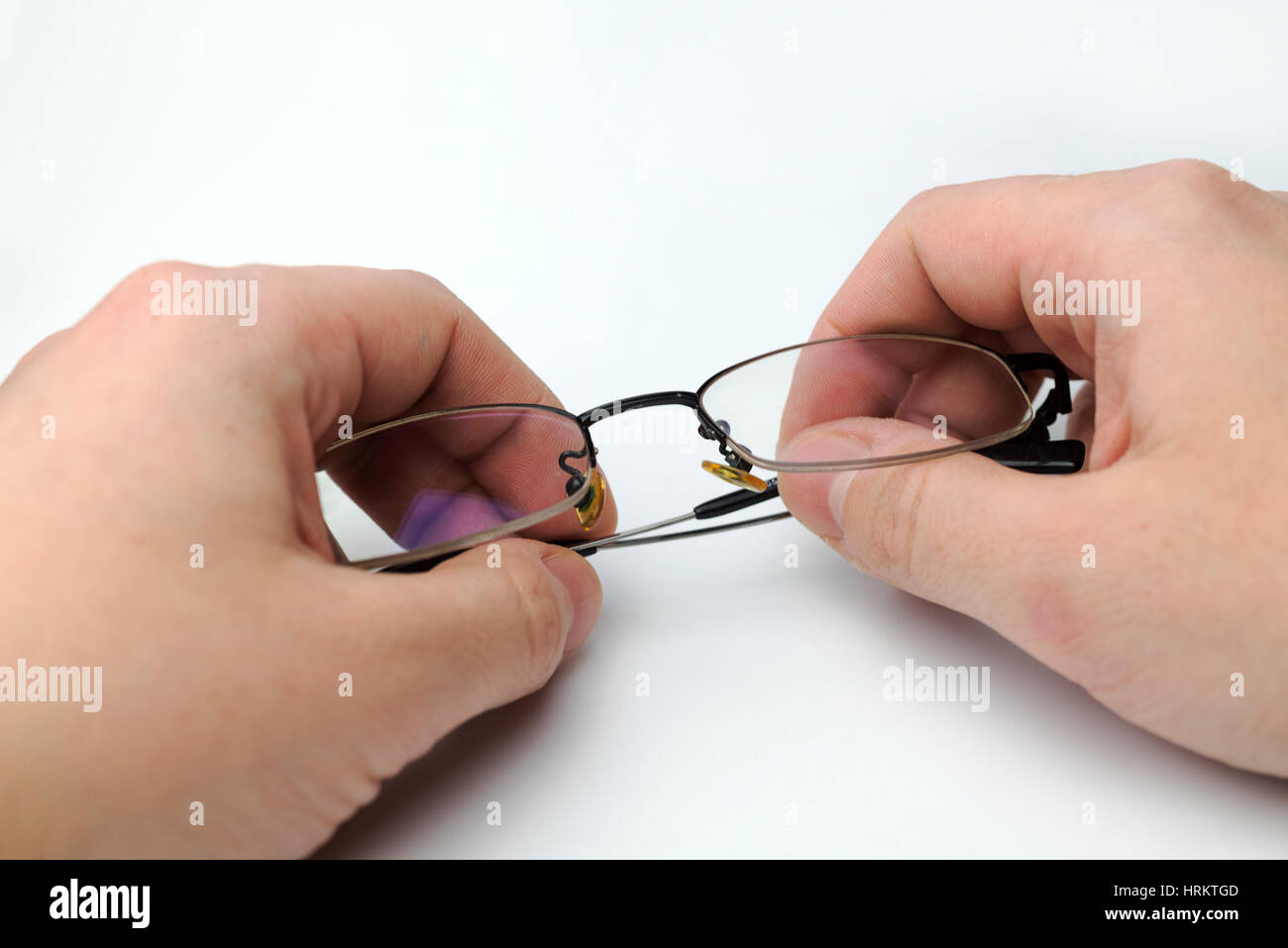 Hands holding glasses on white background Stock Photo - Alamy