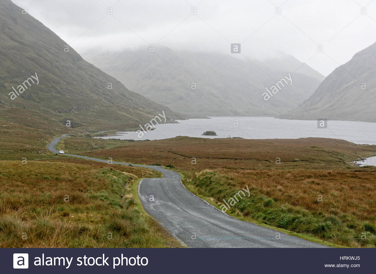 A car climbs a winding road in the Doolough Valley in County Mayo ...