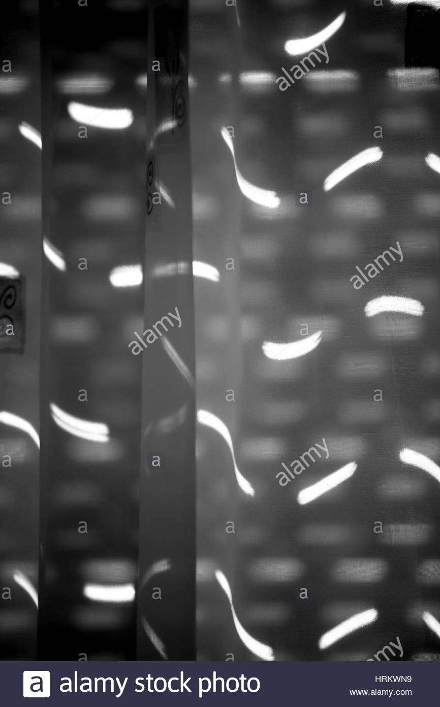 Afternoon light through a shutter creates unusual patterns on indoor ...