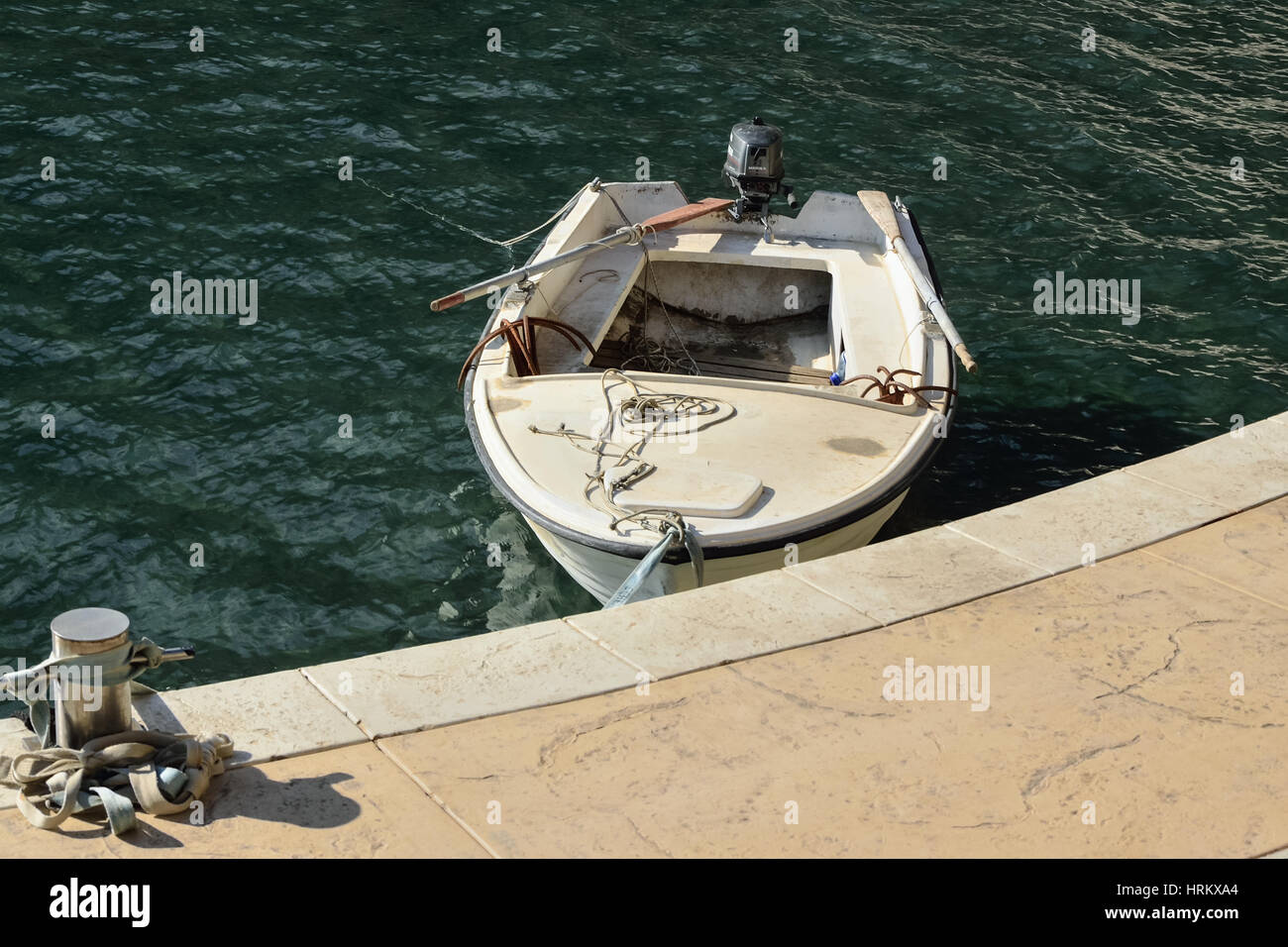 Small white boat in the harbor Stock Photo - Alamy
