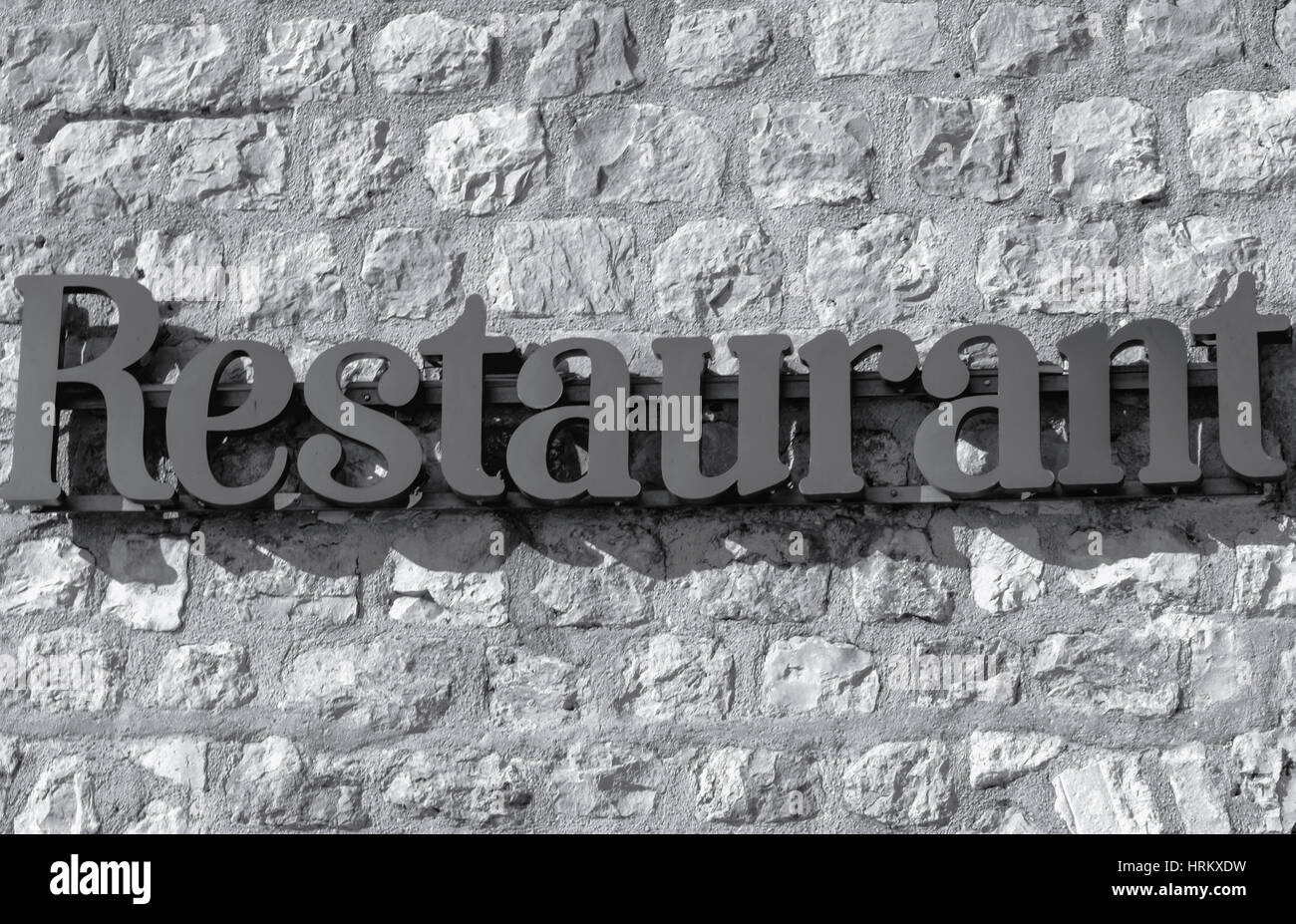 Written "Restaurant" on the stone wall Stock Photo - Alamy