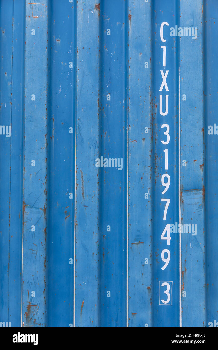 Identification numbers on blue rusty container Stock Photo - Alamy