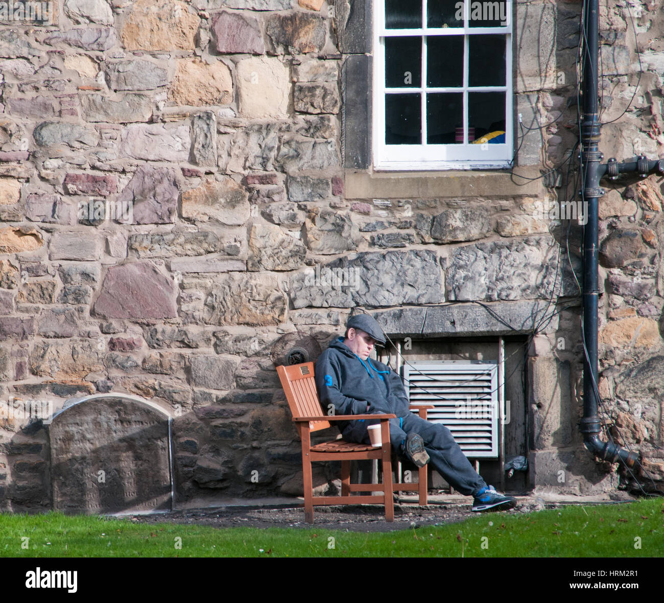 Man dozing on bench in Greyfriars kirkyard, Edinburgh Stock Photo - Alamy