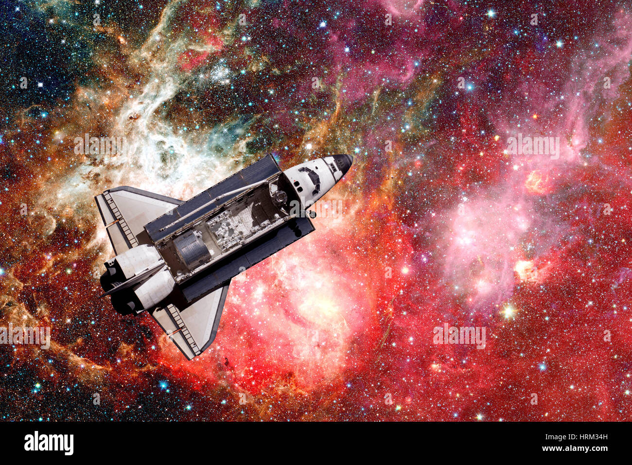 Space Shuttle over galaxy and space nebula. Elements of this image ...