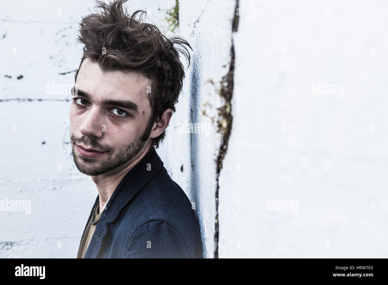A closeup portrait of a serious looking young man Stock Photo - Alamy