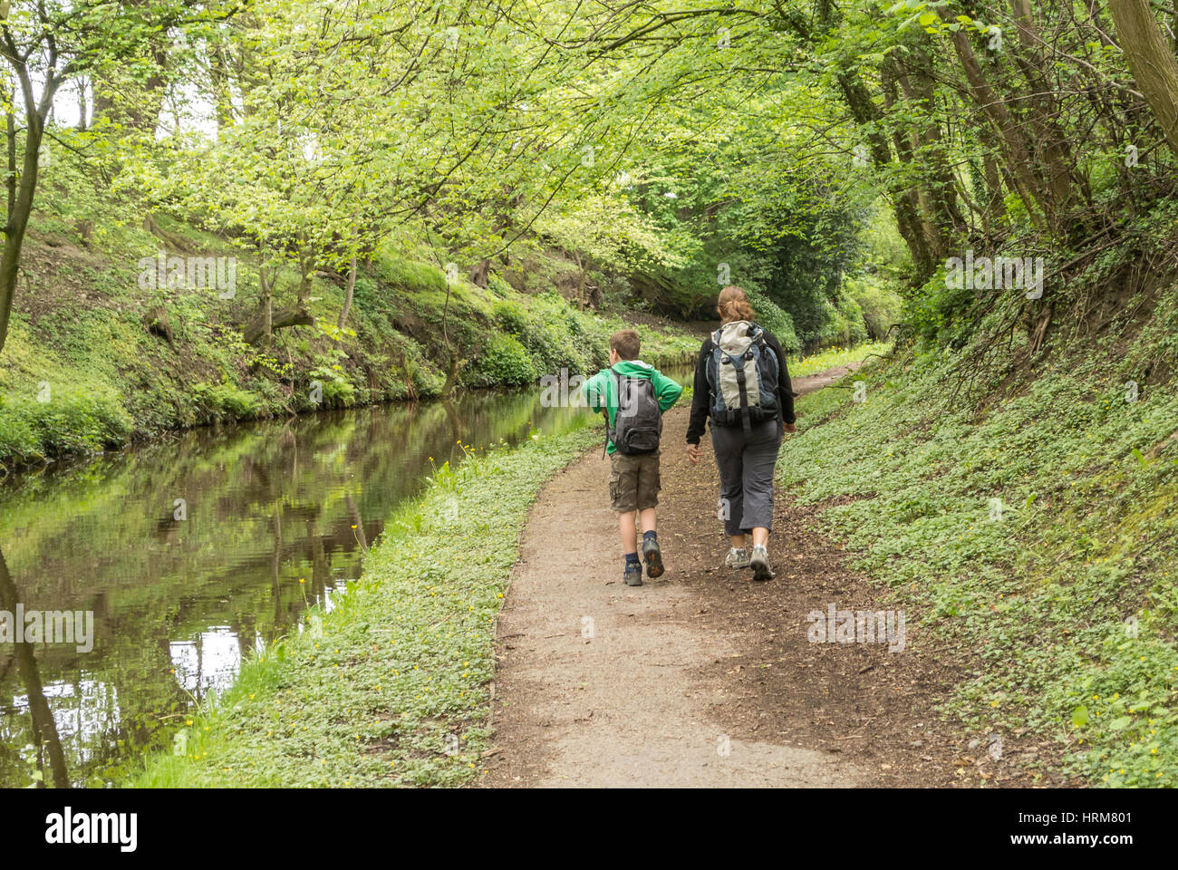 A woman and boy walk along the towpath of the Shropshire Union Canal ...