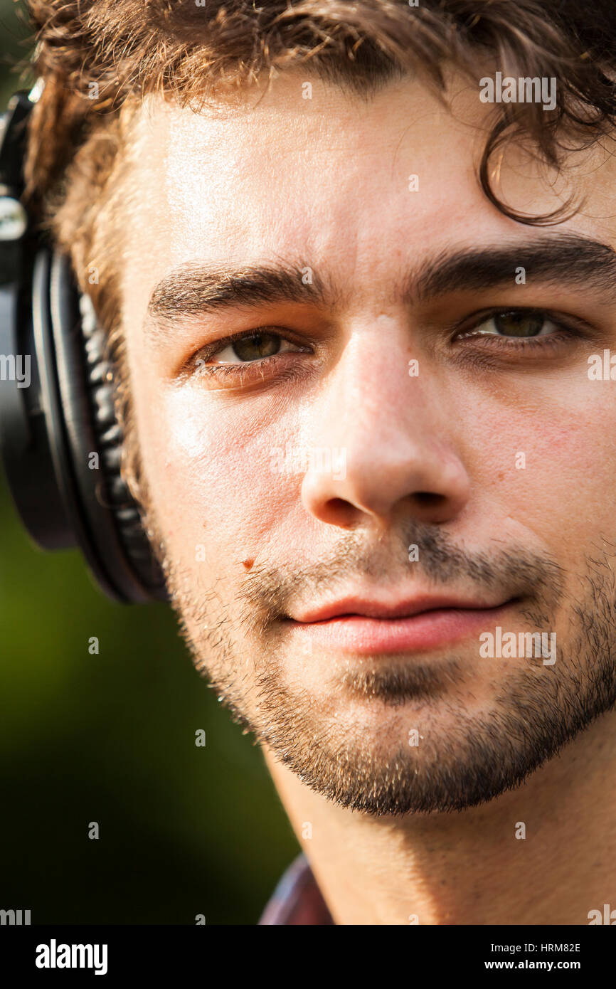A portrait of a young man wearing audio headphones Stock Photo - Alamy
