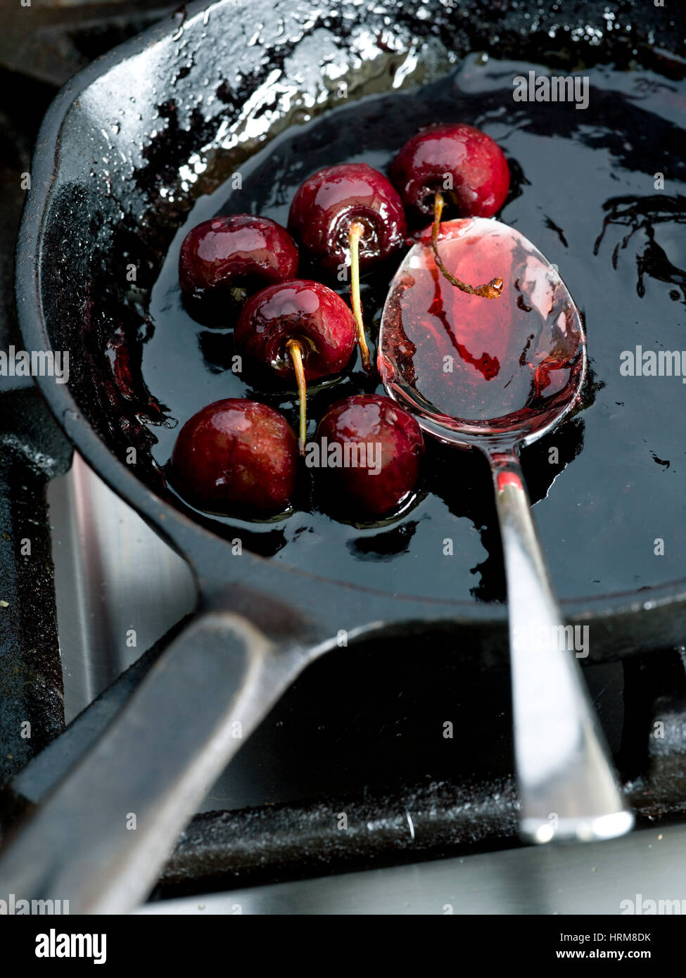 sticky sweet sauce in frying pan being made from cherries Stock Photo ...