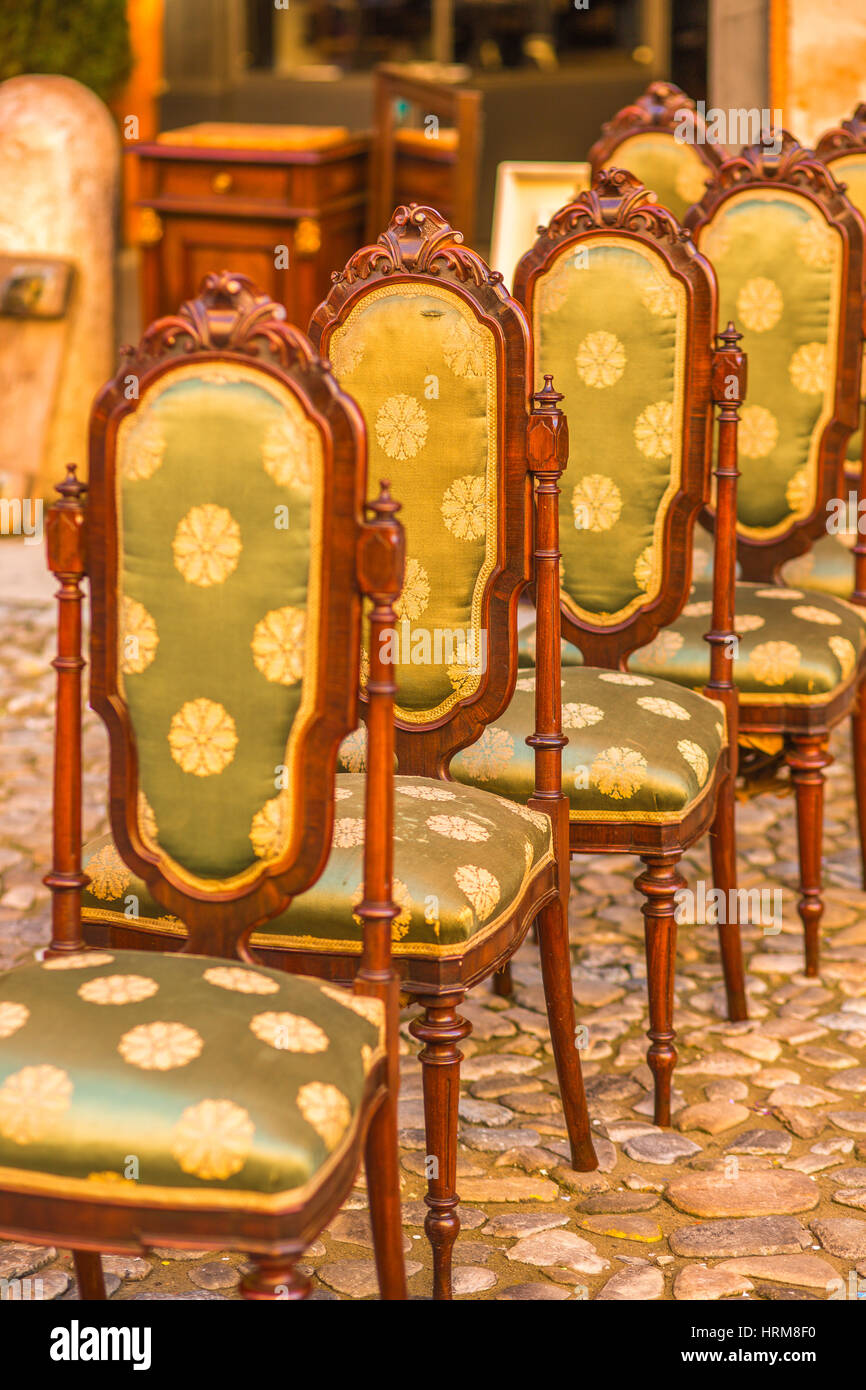 rows of antique chairs with padded back in antiques Fair Stock Photo ...