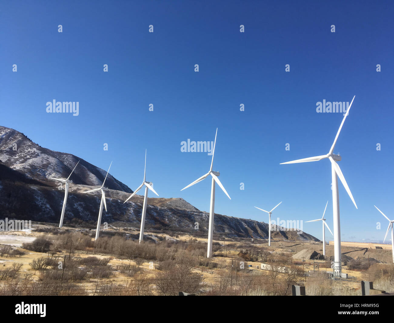 Giant wind turbines create clean, renewable energy. Blue skies and ...